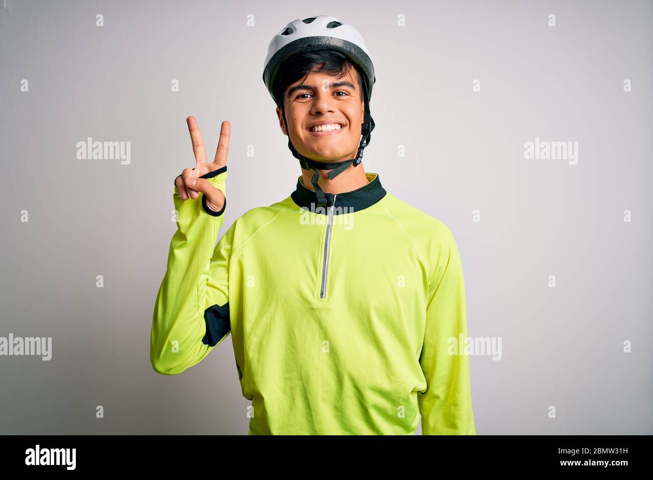 Young handsome cyclist man wearing security bike helmet over isolated ...