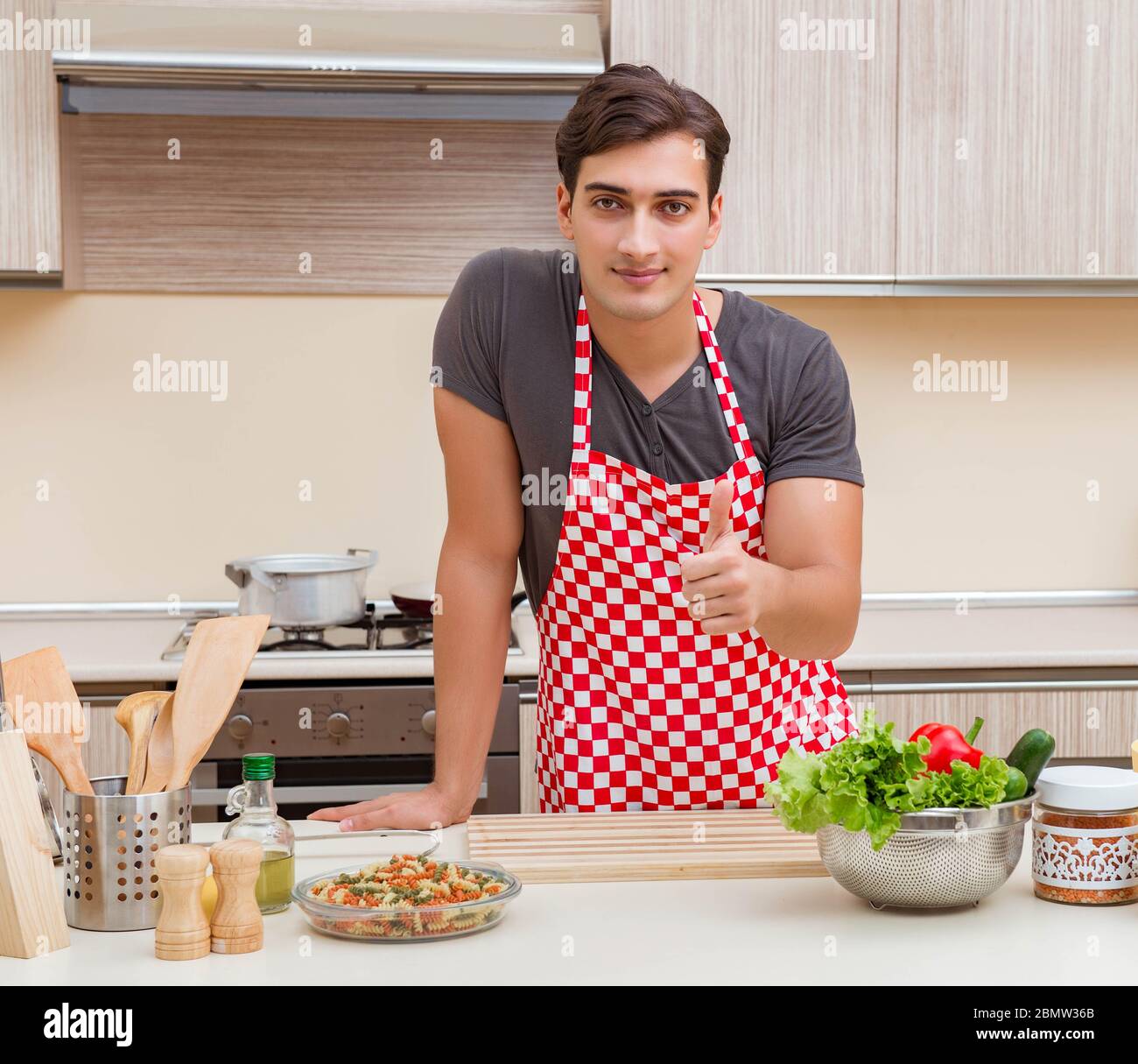 The man male cook preparing food in kitchen Stock Photo - Alamy