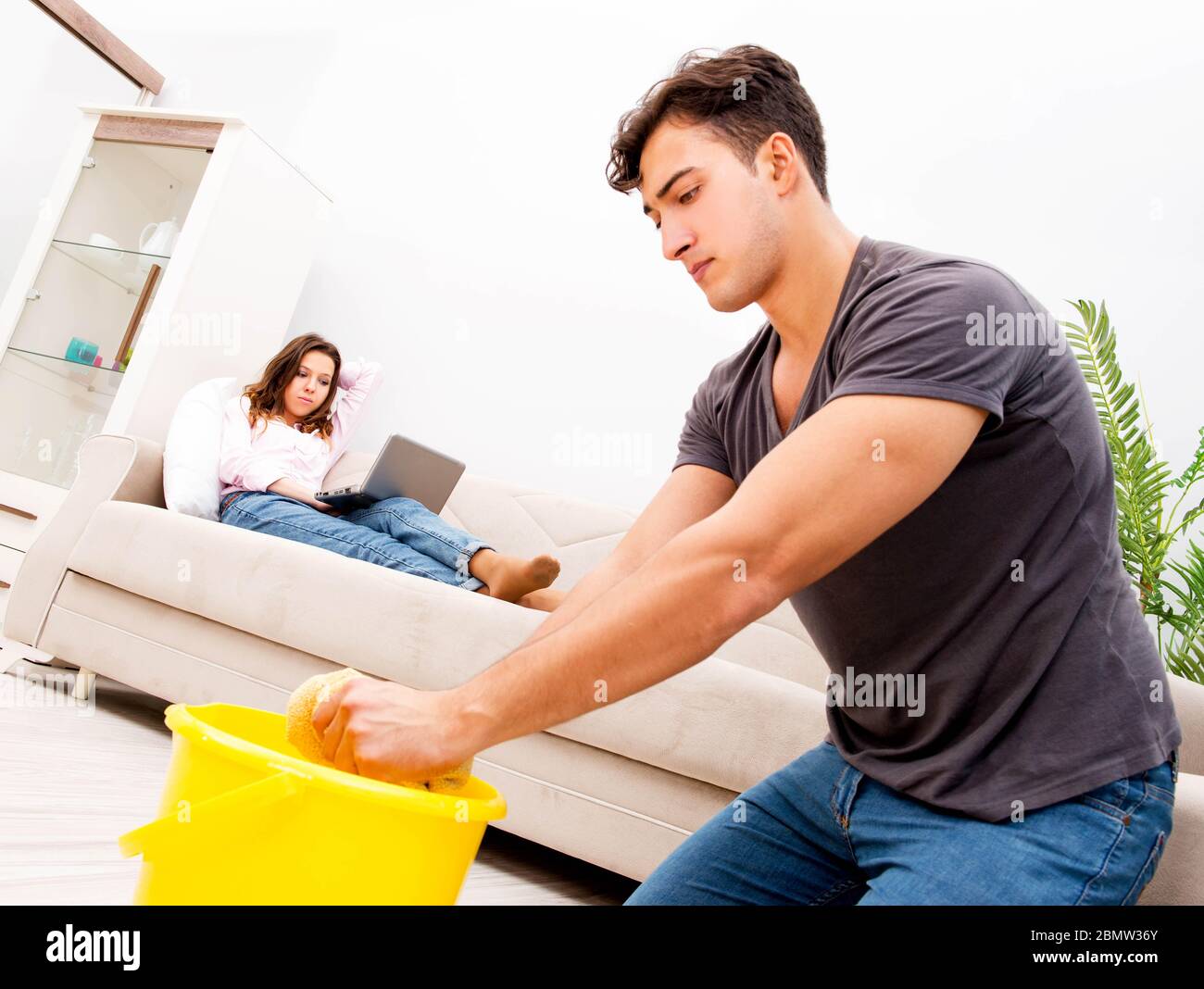 House floor cleaning concept with wife and husband Stock Photo - Alamy