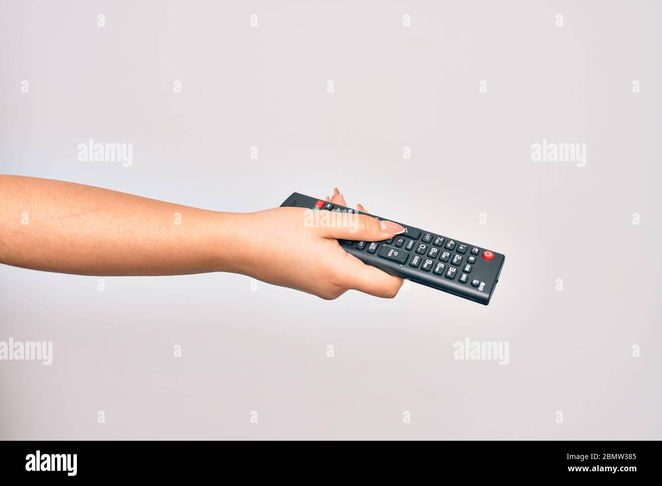 Hand of caucasian young woman changing television channel holding tv ...