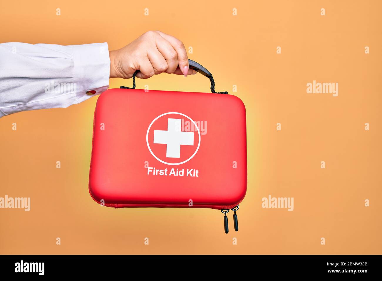 Hand of caucasian young woman holding first aid kit briefcase over ...