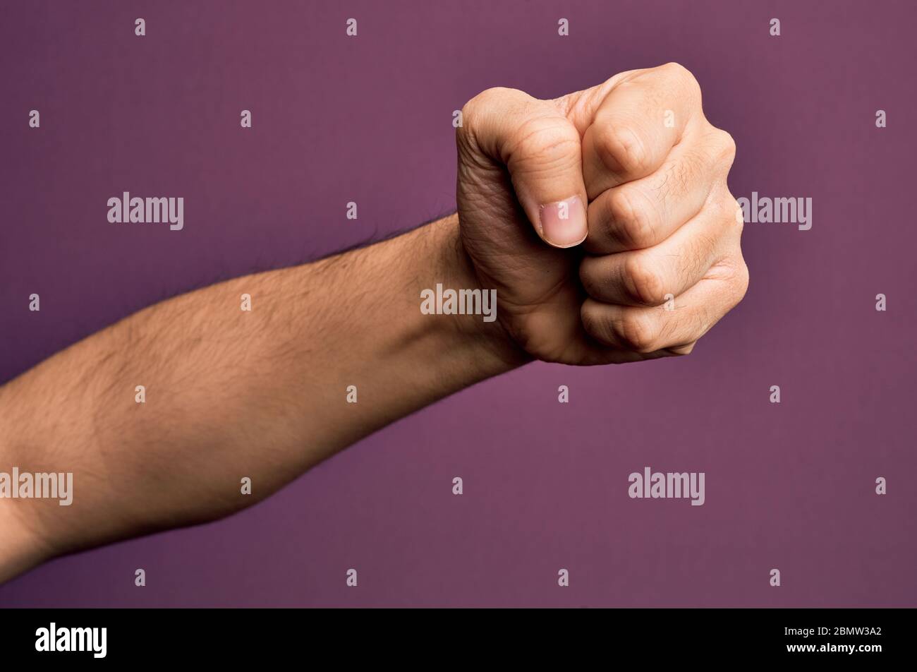 Hand of caucasian young man showing fingers over isolated purple ...