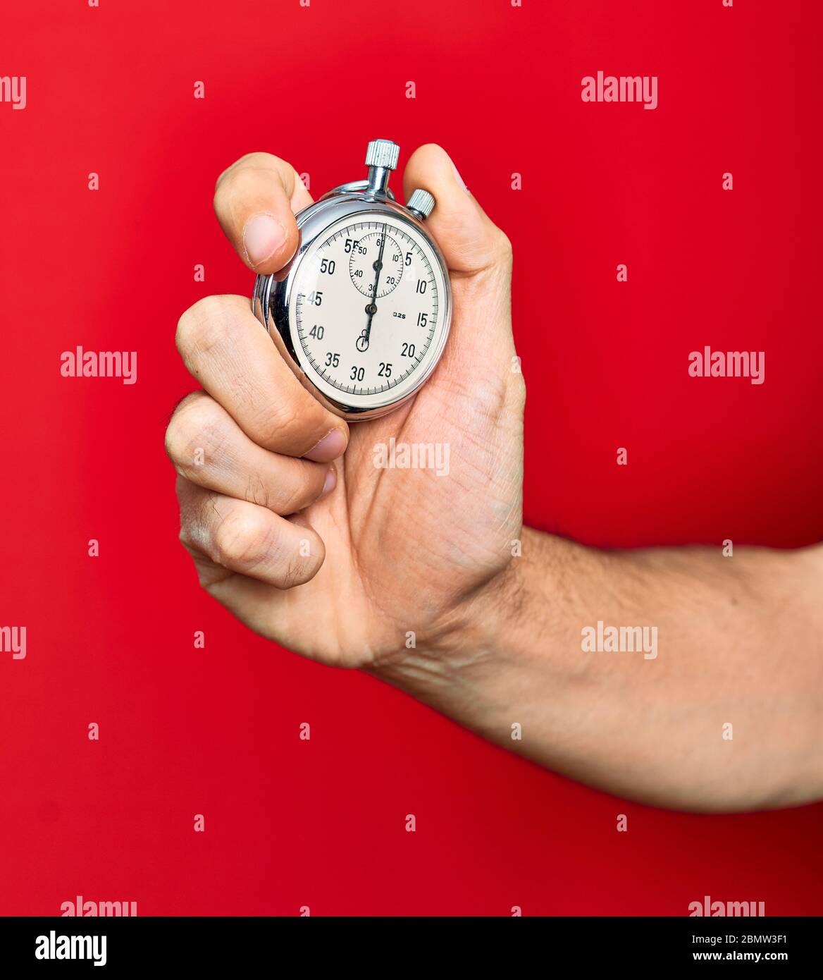 Beautiful hand of man holding stopwatch doing countdown over isolated ...