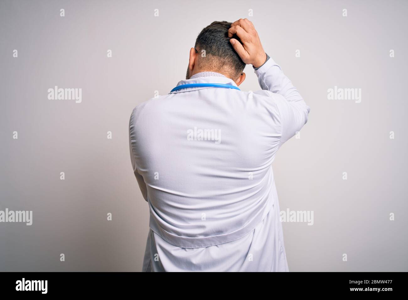 Young doctor man with blue eyes wearing medical coat and stethoscope ...
