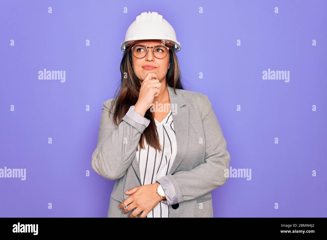 Professional woman engineer wearing industrial safety helmet over ...