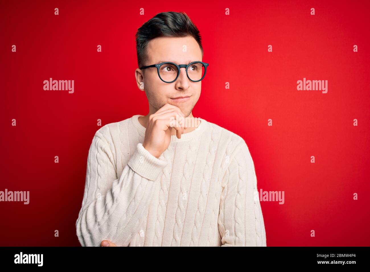 Young handsome caucasian man wearing glasses and casual winter sweater ...