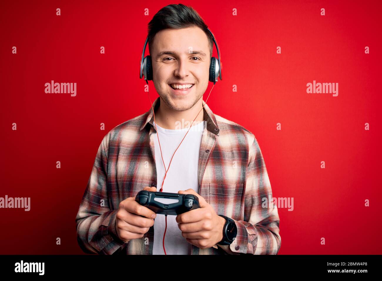 Young handsome caucasian gamer man playing video games using console ...