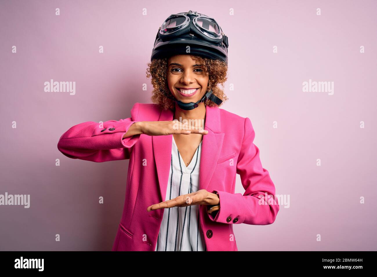 African american motorcyclist woman with curly hair wearing moto helmet ...