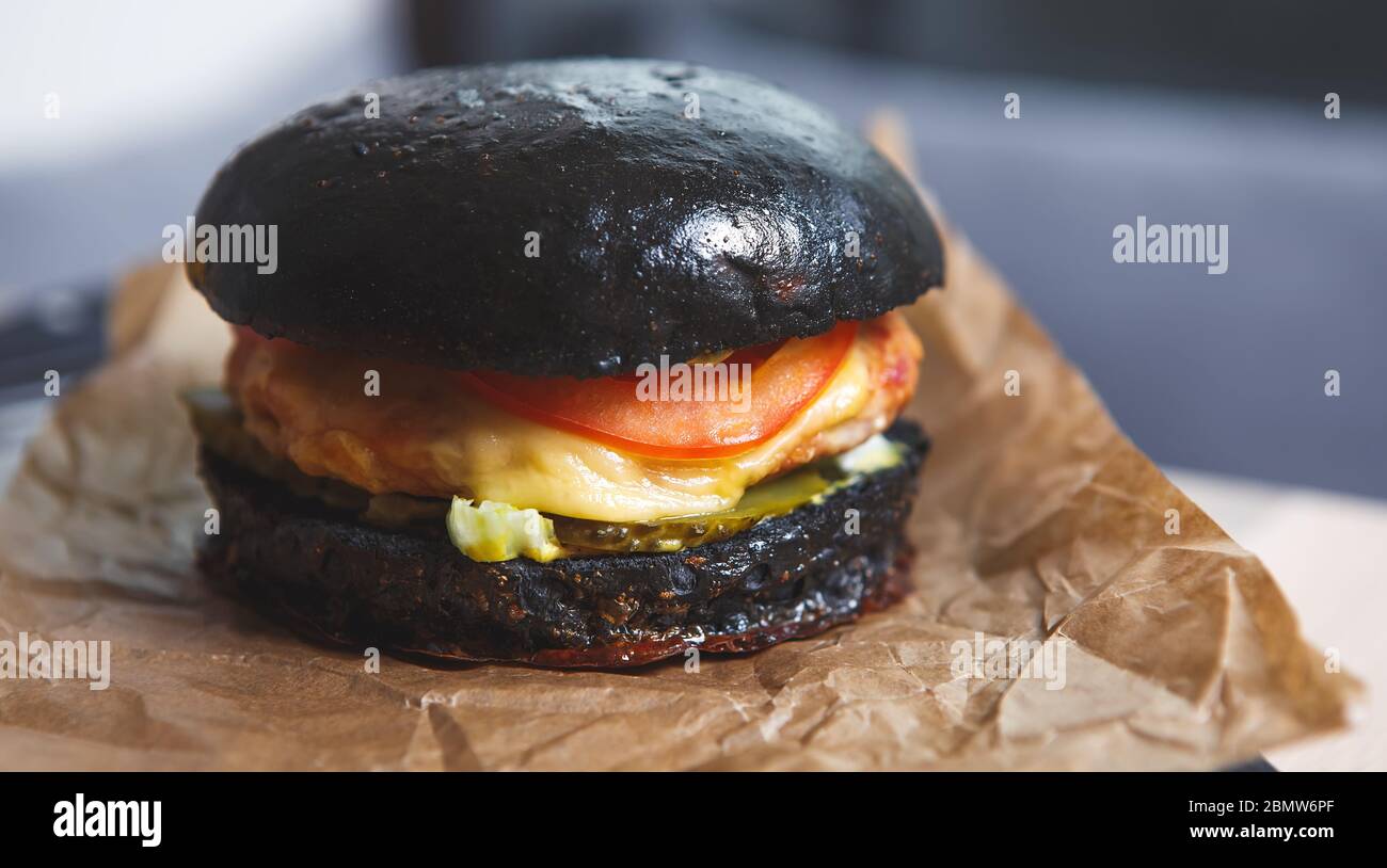 Delicious black burger delivered.Fast food delivery served on brown ...
