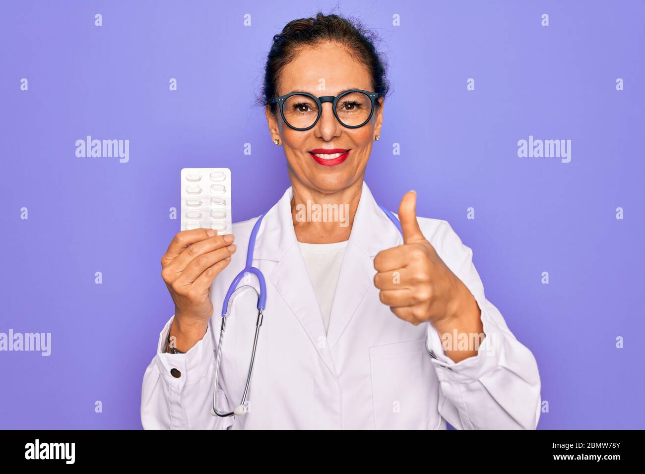 Middle age senior professional doctor woman holding pharmaceutical ...