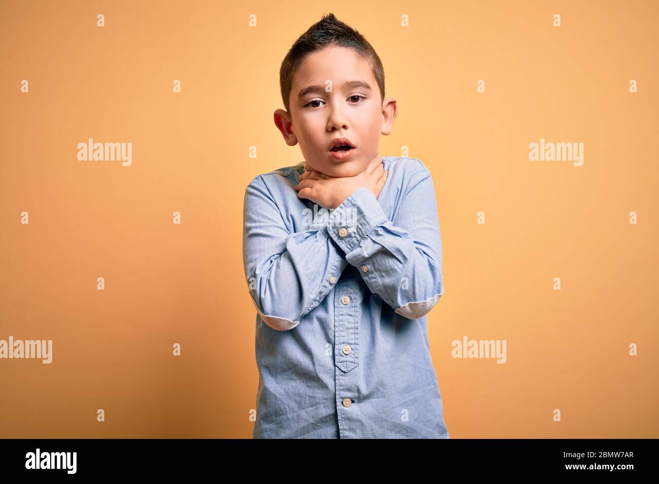 Young little boy kid wearing elegant shirt standing over yellow ...