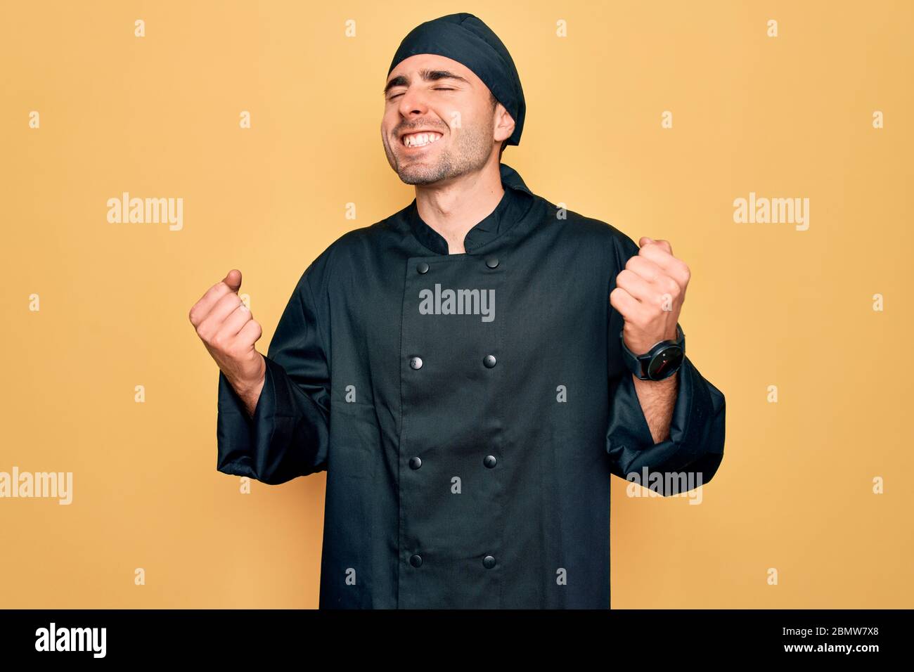 Young handsome cooker man with blue eyes wearing uniform and hat over ...