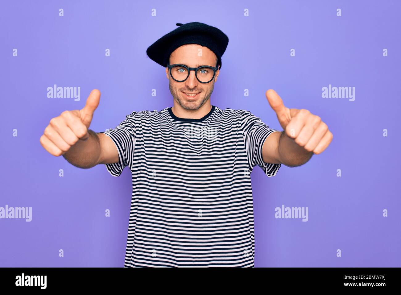 Handsome man with blue eyes wearing striped t-shirt and french beret ...