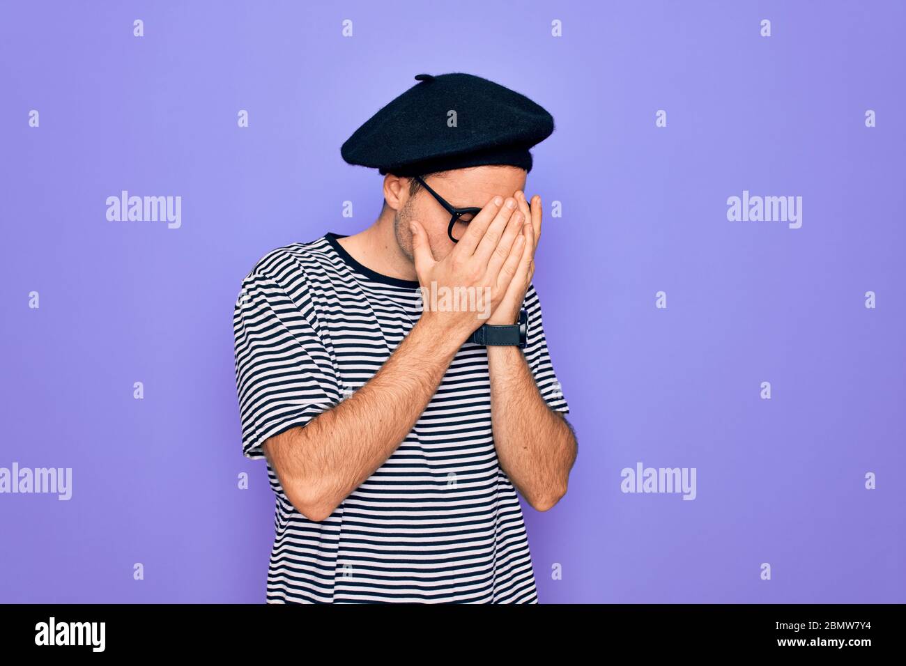 Handsome man with blue eyes wearing striped t-shirt and french beret ...