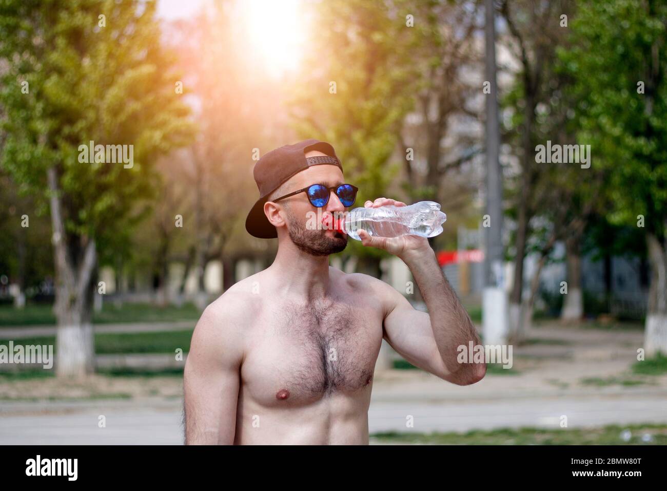 strong young man drinking water after hard exercises outdoor Stock ...