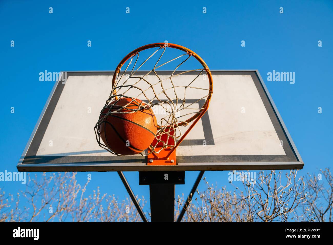 Street basketball ball falling into the hoop. Urban youth game. Close ...