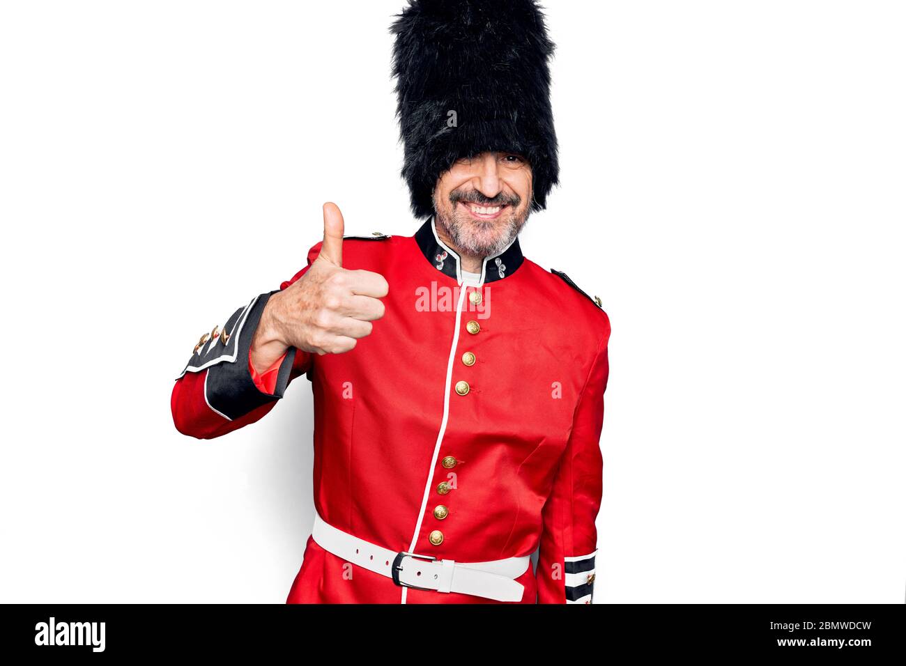 Middle age handsome wales guard man wearing traditional uniform over ...