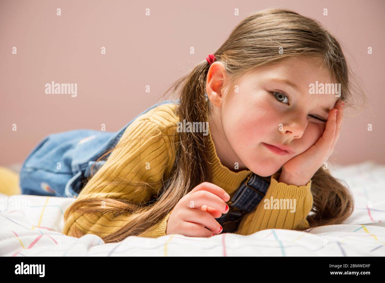 Young girl looking bored at home Stock Photo - Alamy