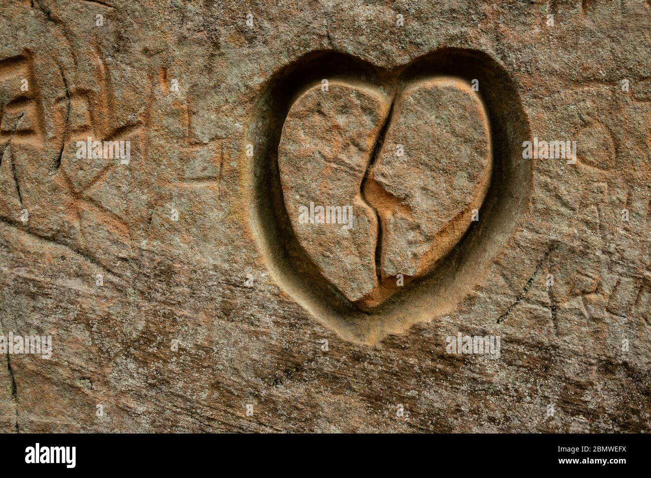 Broken heart carved in sandstone rock Stock Photo - Alamy