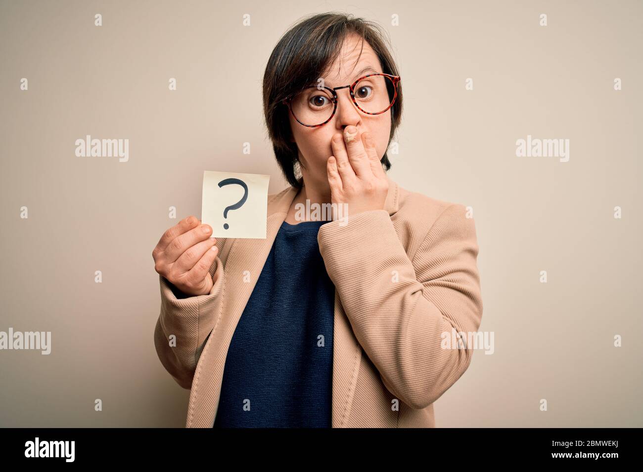 Young down syndrome business woman holding question mark paper as doubt ...
