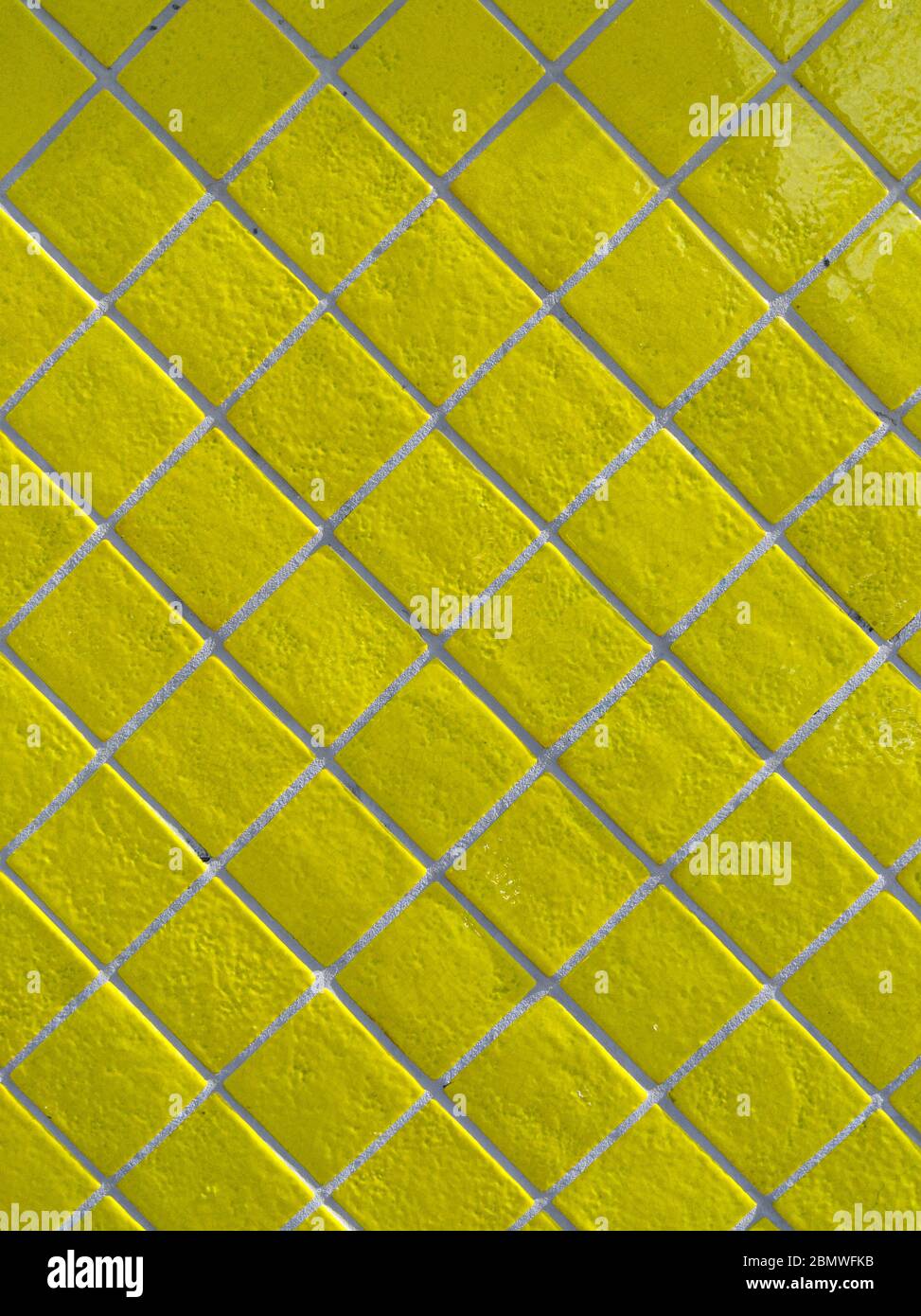 Yellow tiled wall pattern with textured glazed surface Stock Photo - Alamy