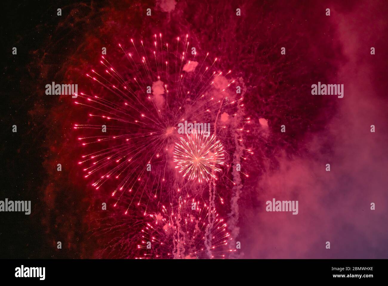 Red firework with smoke over the black sky. Low key exposure Stock ...