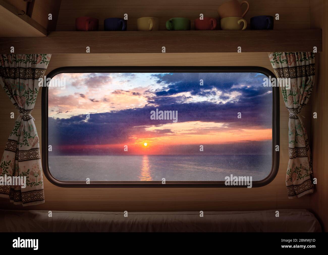 View from window camper of stunning dusk over calm ocean Stock Photo ...