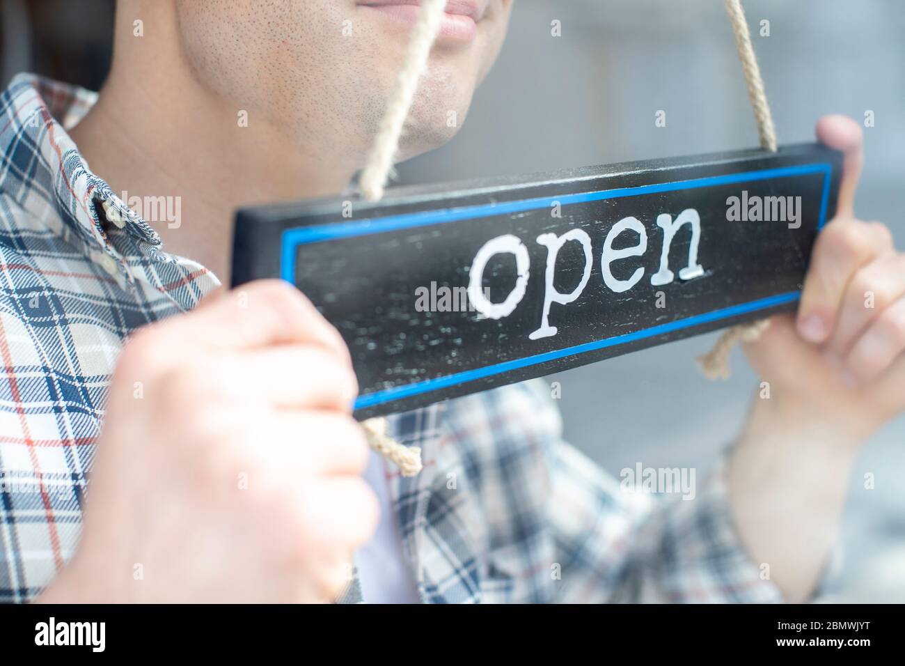 Man turning close sign to open sign hi-res stock photography and images ...
