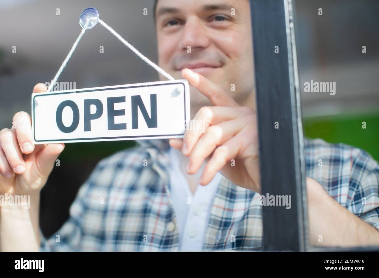 Man turning close sign to open sign hi-res stock photography and images ...