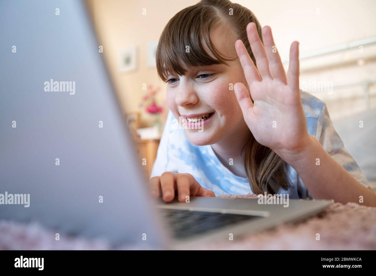 Smiling Girl In Bedroom Talking With Friends On Social Media Using ...
