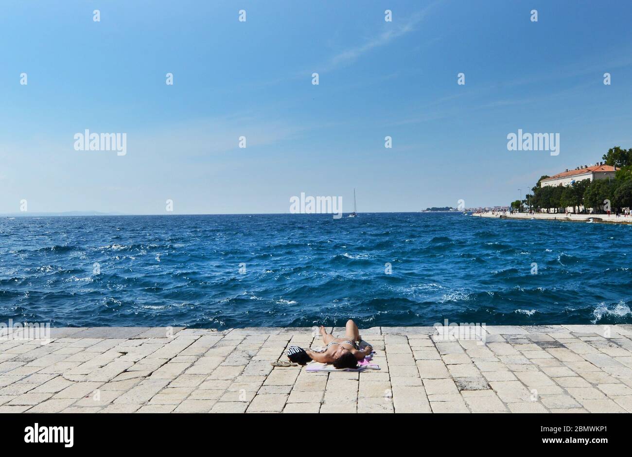 Sunbathing on the Nova Riva promenade in Zadar, Croatia Stock Photo - Alamy