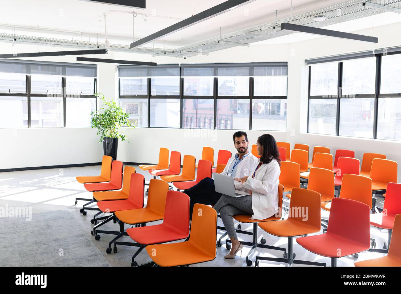 Doctors in a conference room using a laptop Stock Photo - Alamy