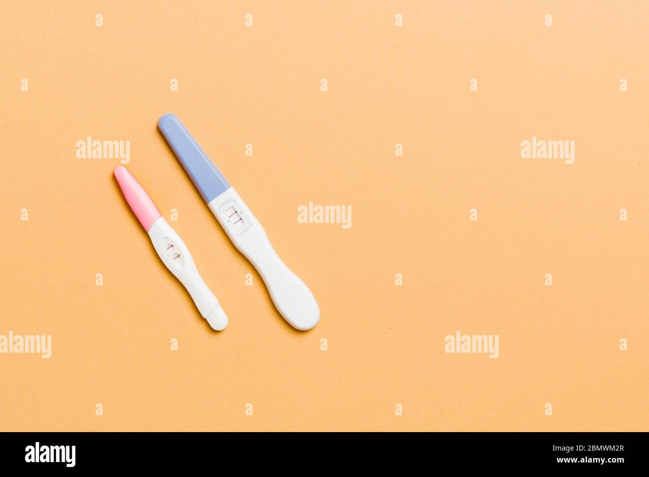 Colored Pregnancy test on colored background, top view with copy space ...