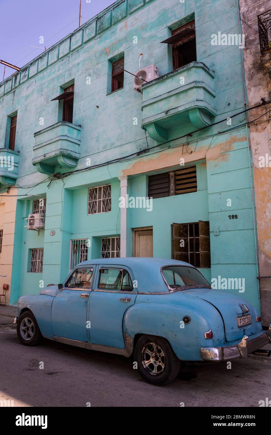Old, run-down car parked in front of a house, Havana Centro district ...