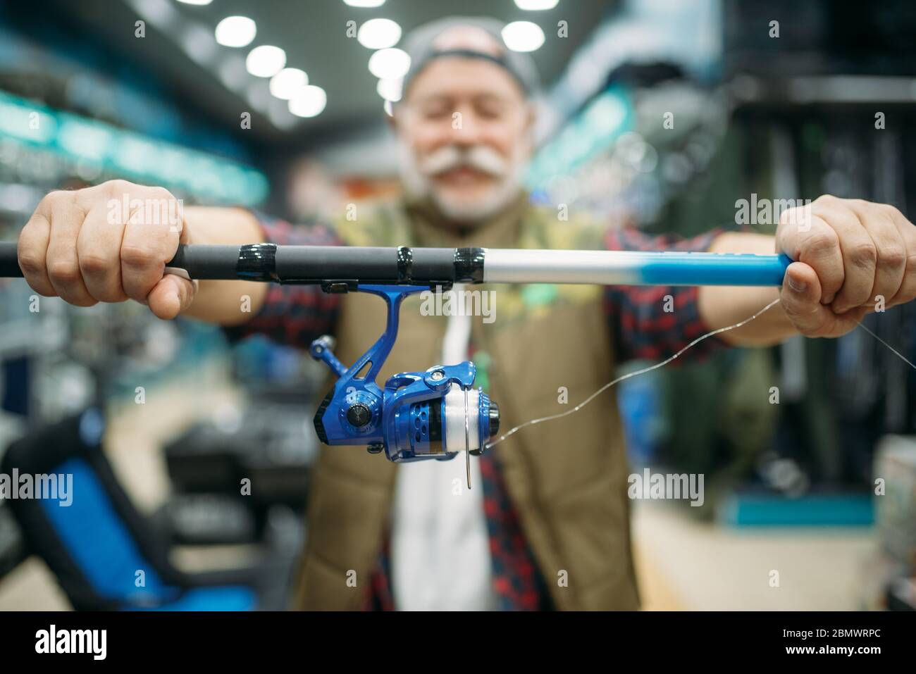 Male angler choosing rod hi-res stock photography and images - Alamy