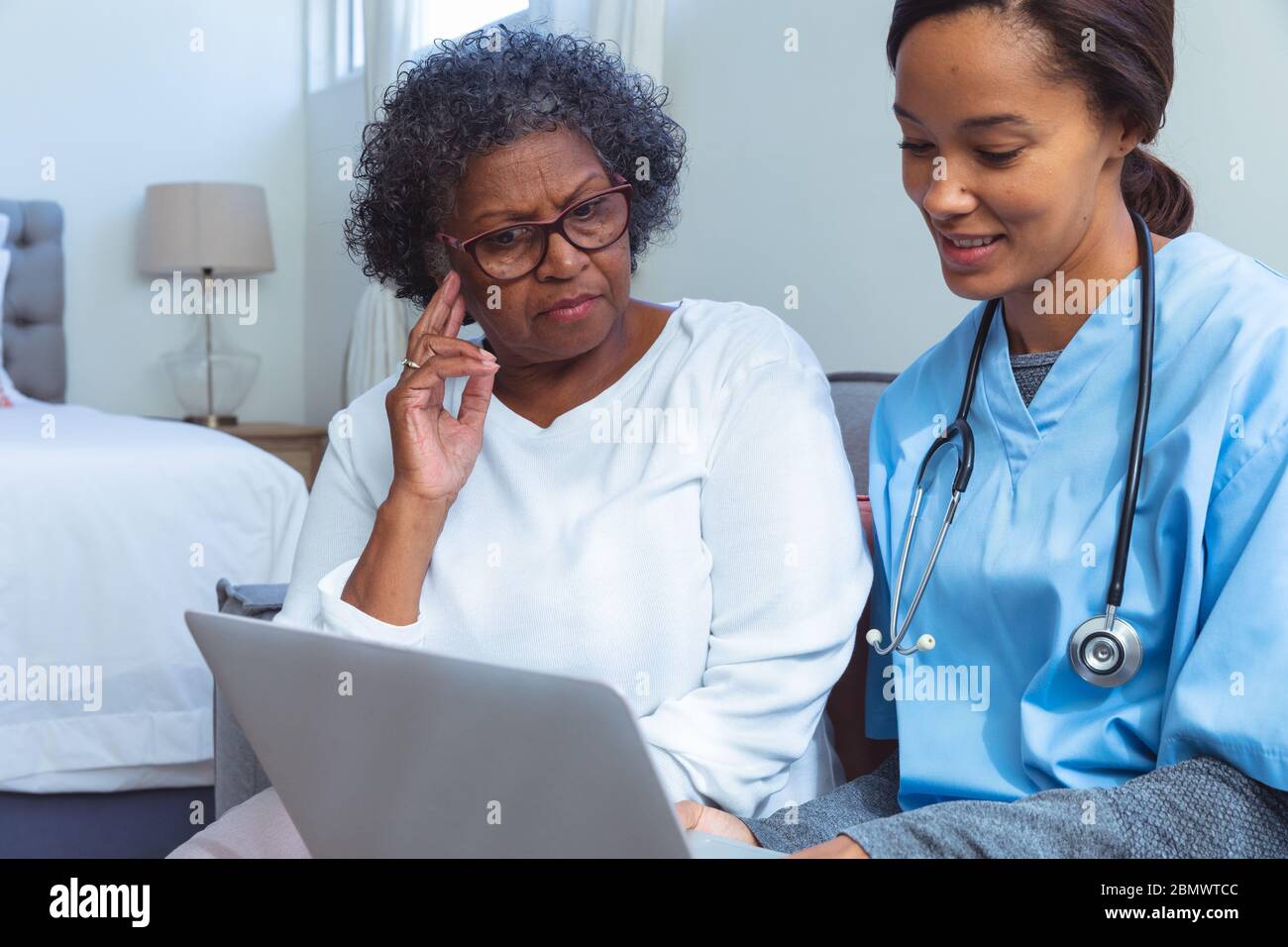 Sick Senior African American woman at home during quarantine lock down ...