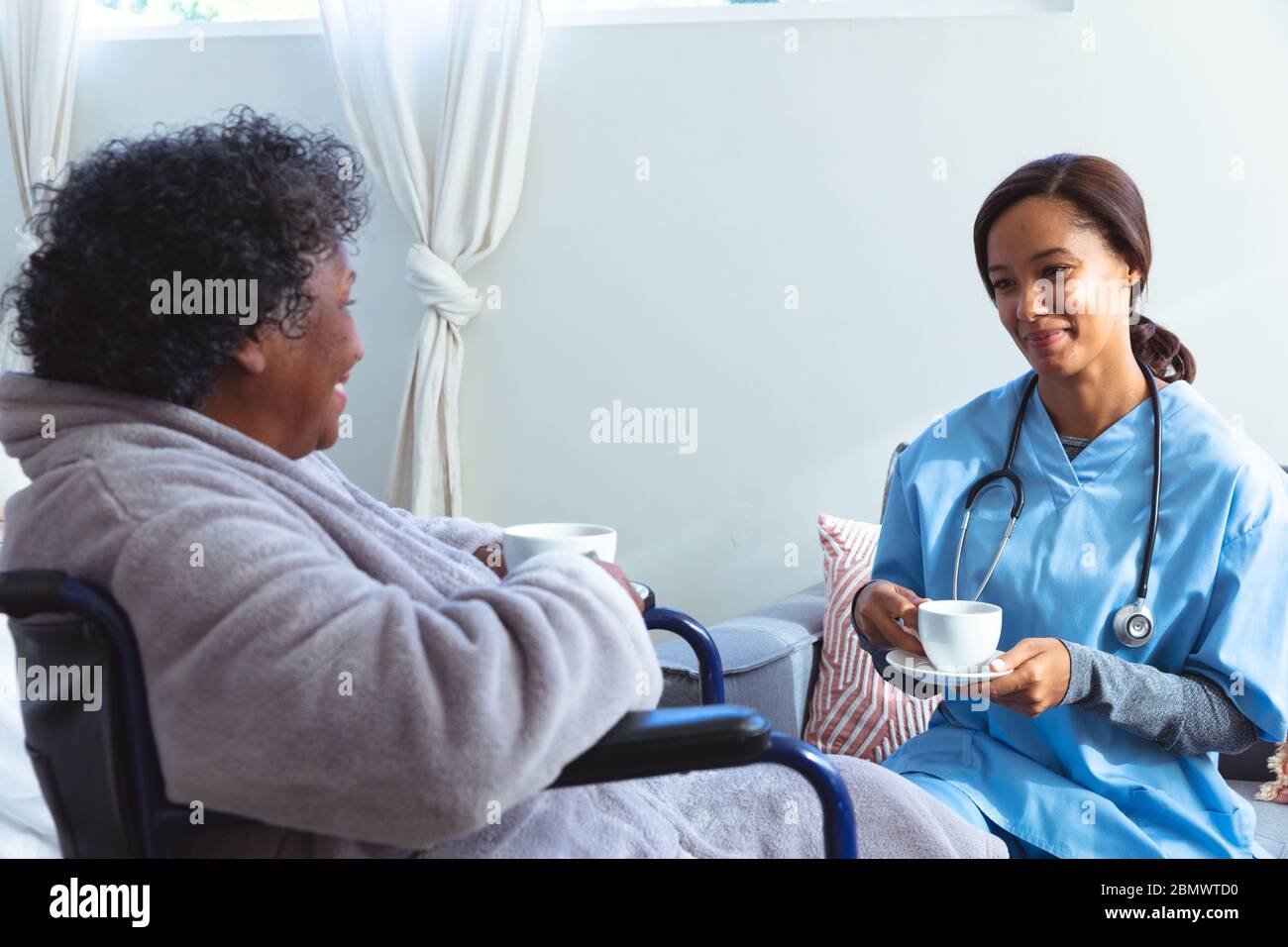 Sick senior African American woman at home during quarantine lock down ...