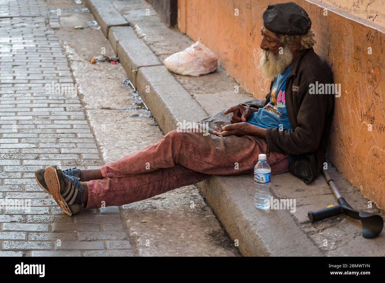 Poor man sitting hi-res stock photography and images - Alamy