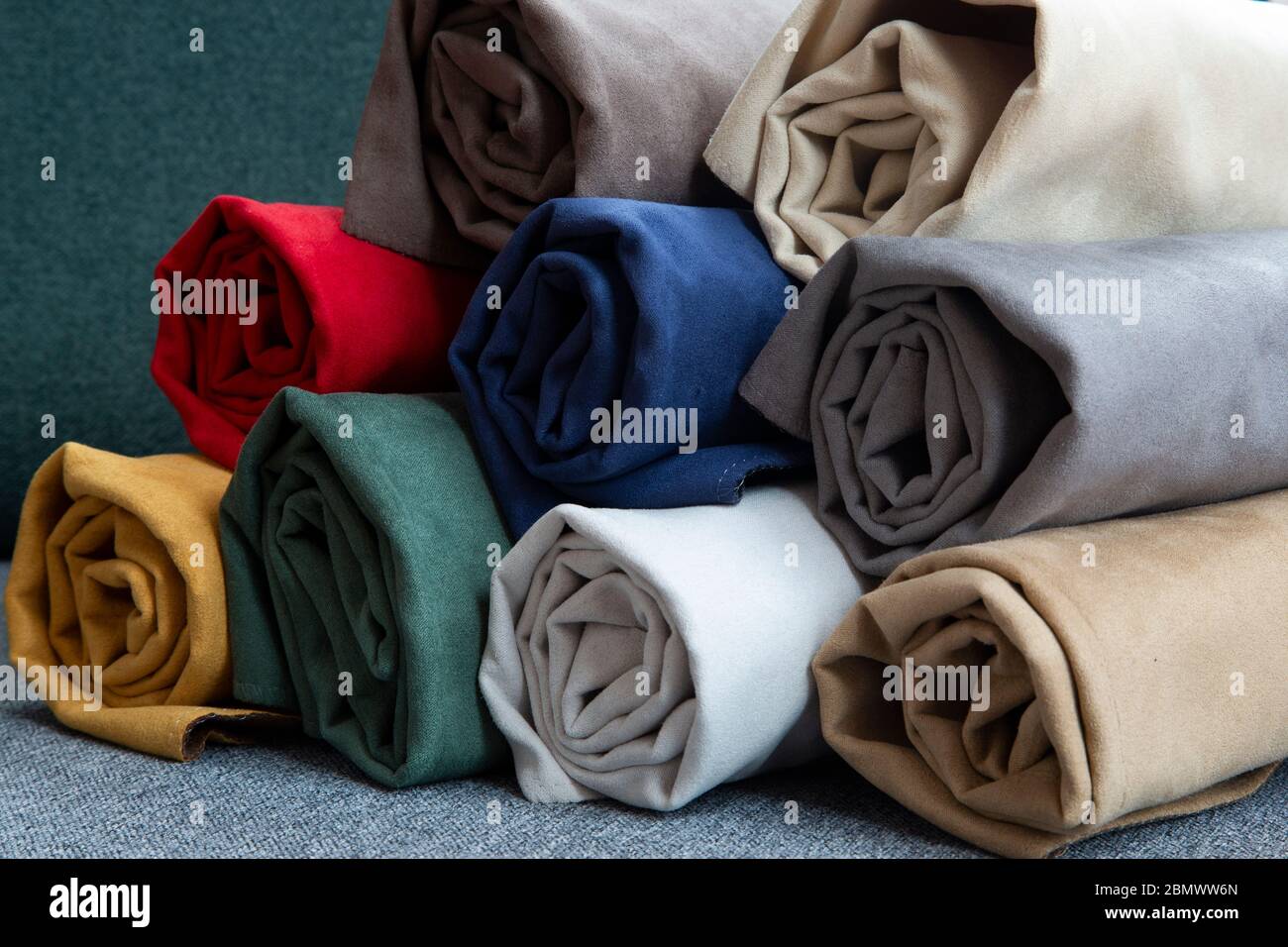 Many different colorful rolls of fabric Stock Photo - Alamy
