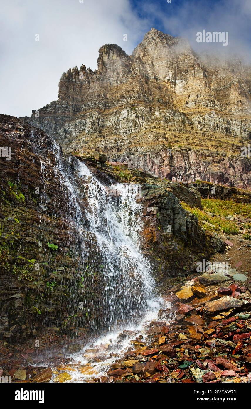 A waterfall along the trail in the Lewis range, Glacier national park ...