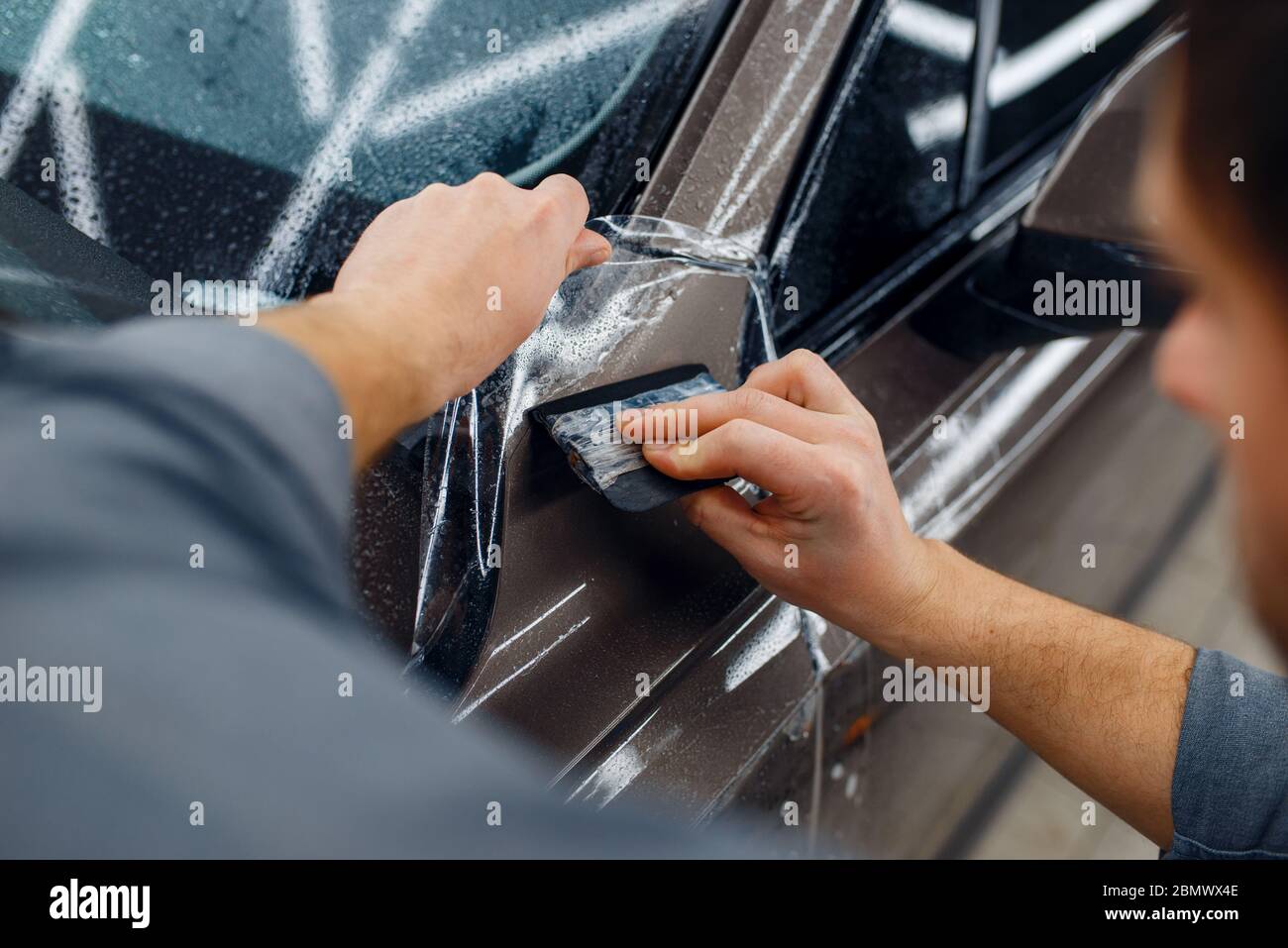 Male worker smoothes car hi-res stock photography and images - Alamy