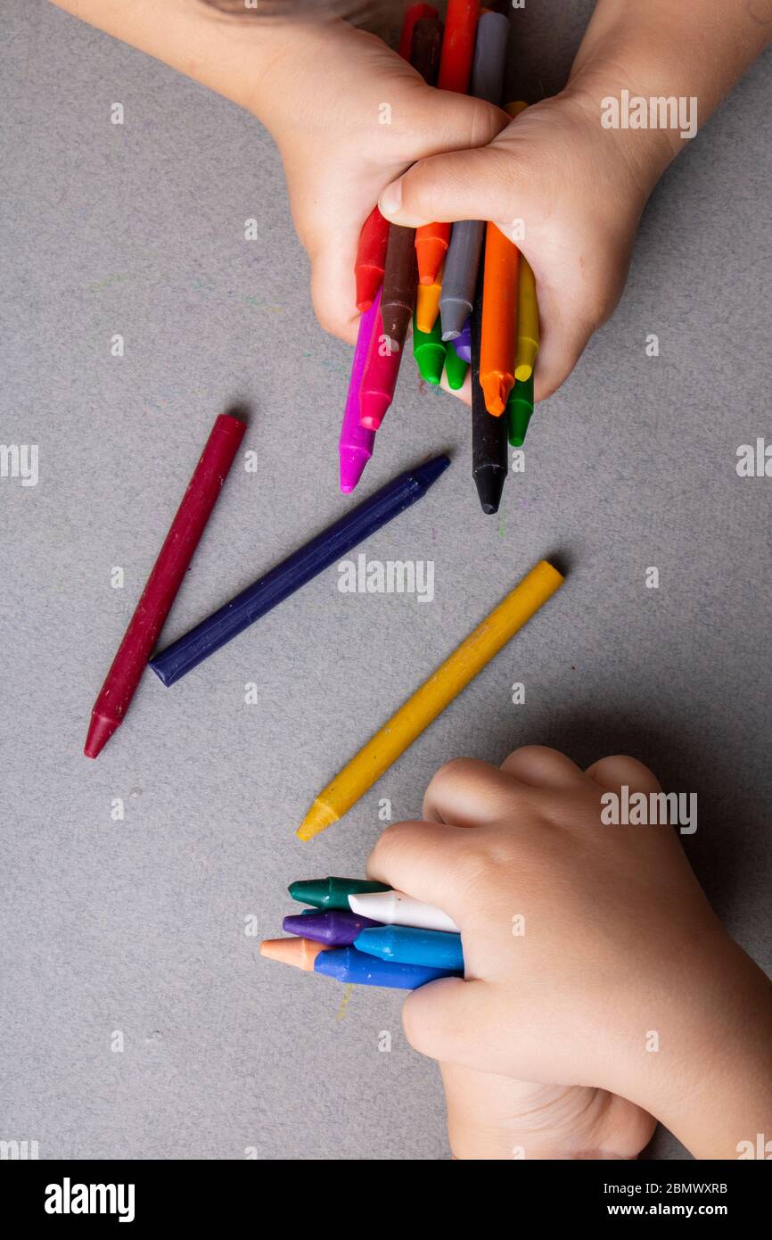 two girls holding wax crayons for drawing, vertical Stock Photo - Alamy