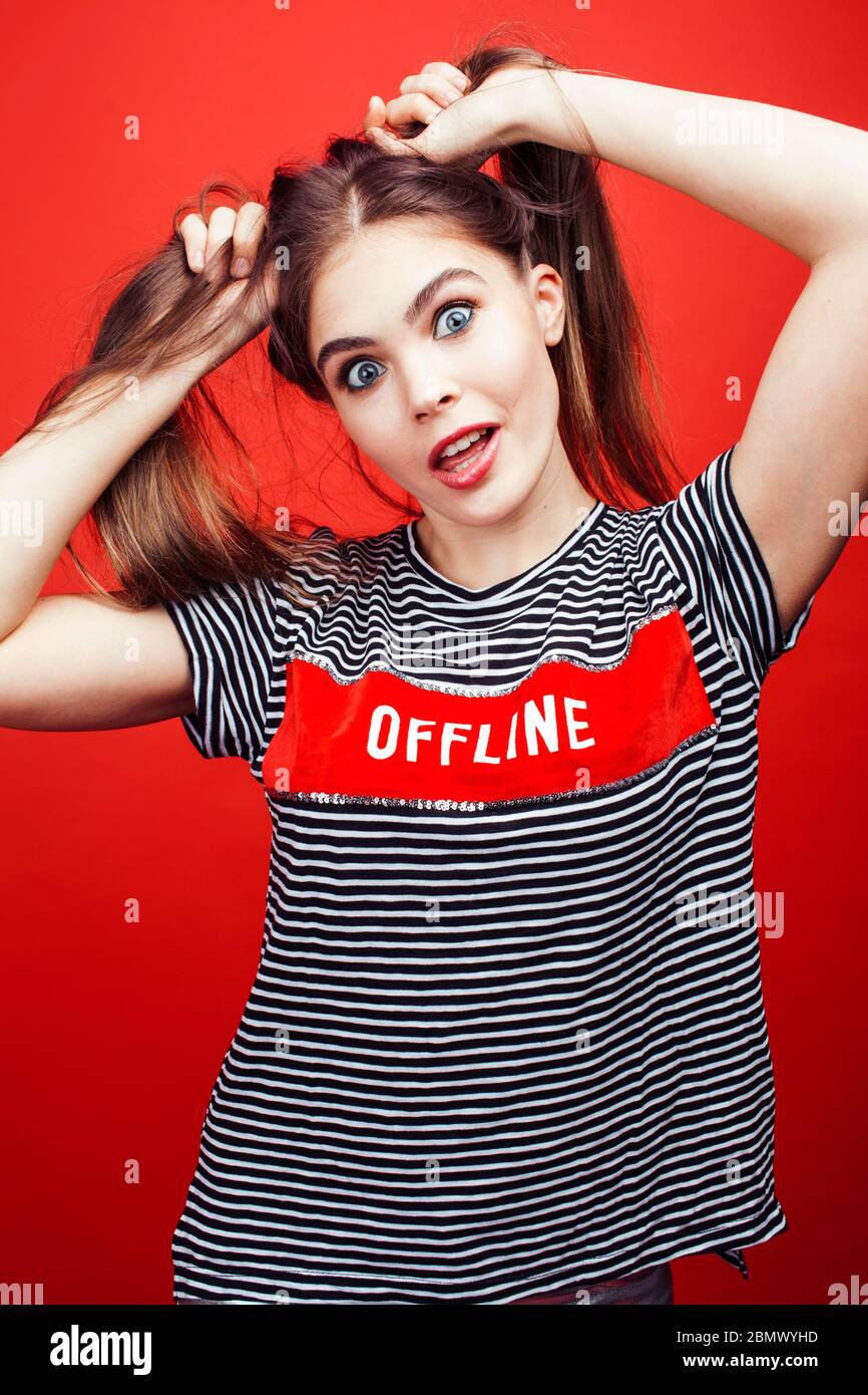 young pretty emitonal posing teenage girl on bright red background ...