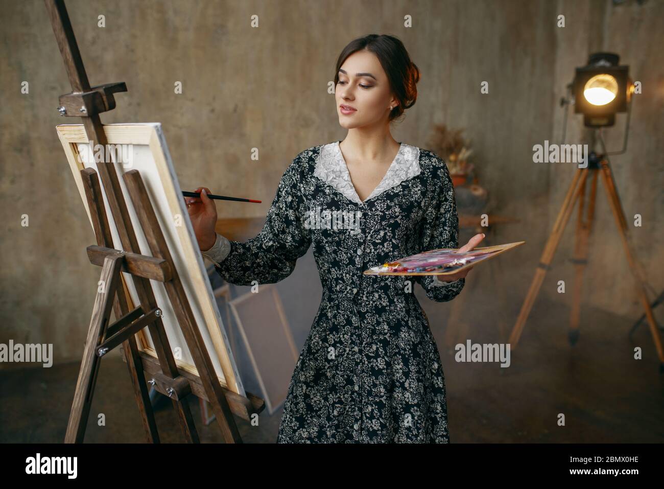 Female painter with brush and palette in studio Stock Photo - Alamy