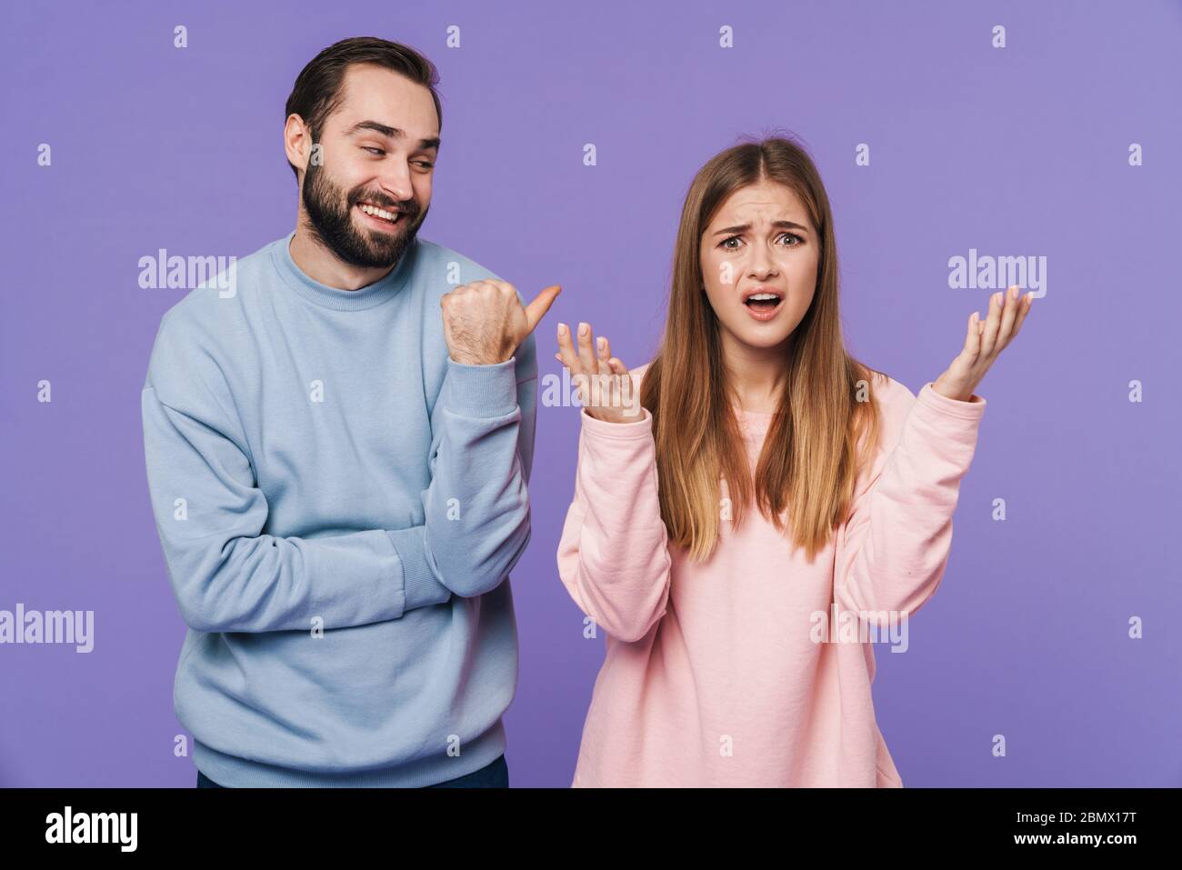 Picture of funny man laughing of confused girlfriend isolated over ...