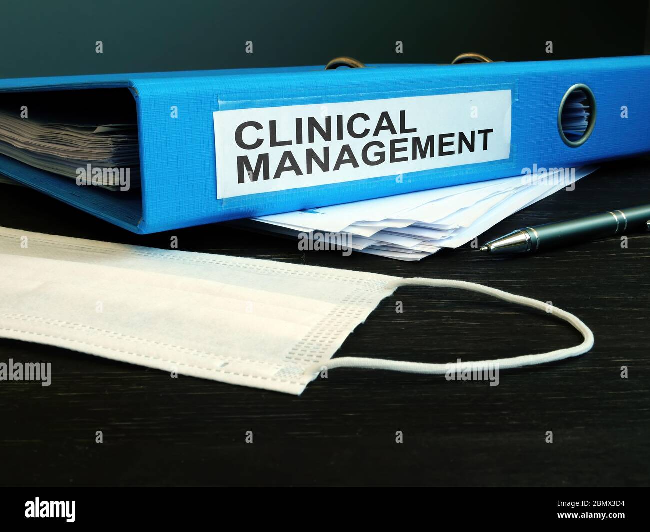 Folder with label clinical management and medical mask Stock Photo - Alamy