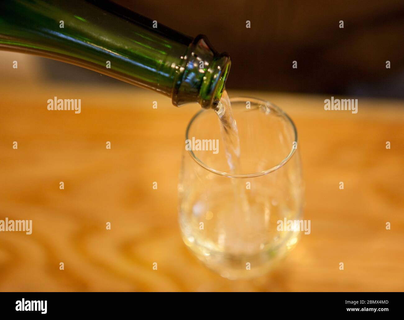 Hard apple cider is poured into a glass at the Finger Lakes Cider House ...