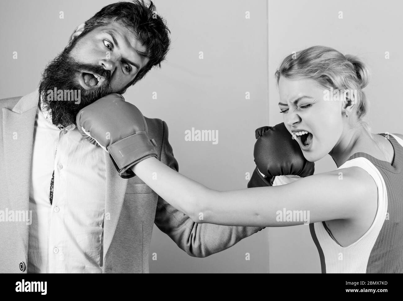 Gender battle. Gender equal rights. Family quarrel. Boxers fighting in ...