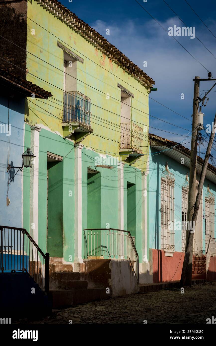 Typical cobblestoned street with colourful houses in the colonial era ...