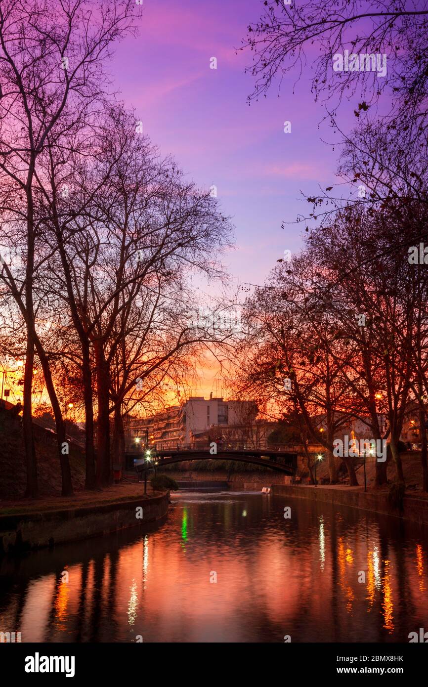 A winter sunset in the river Litheos, in the heart of the city of ...